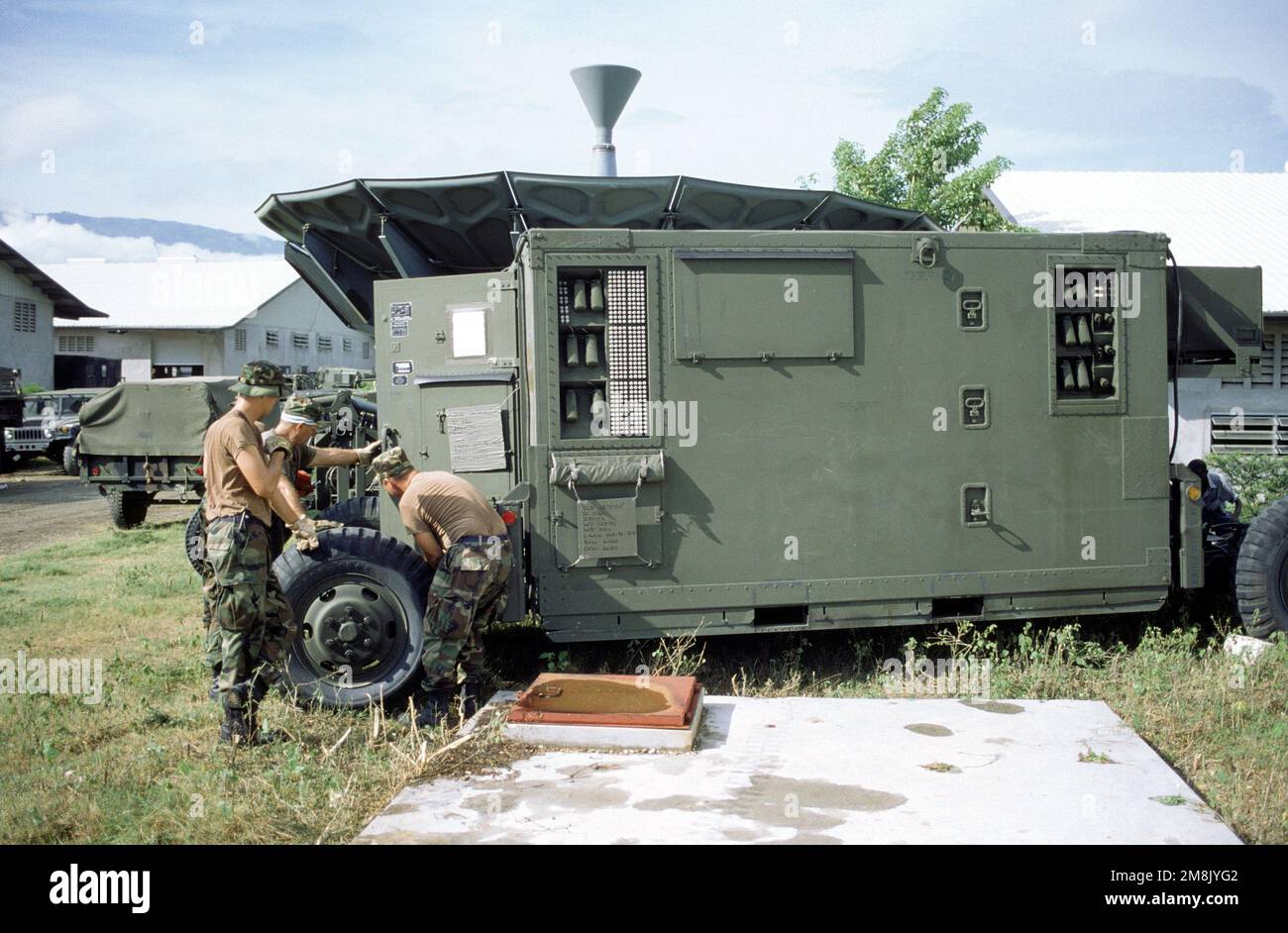 Members of the 3rd Combat Communications Group hook up power lines from ...