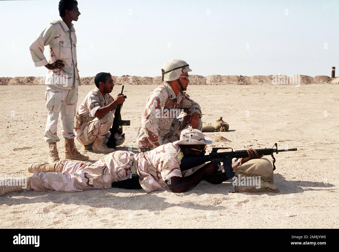 Kuwaiti soldiers fire M-16 rifles on the firing line while being ...
