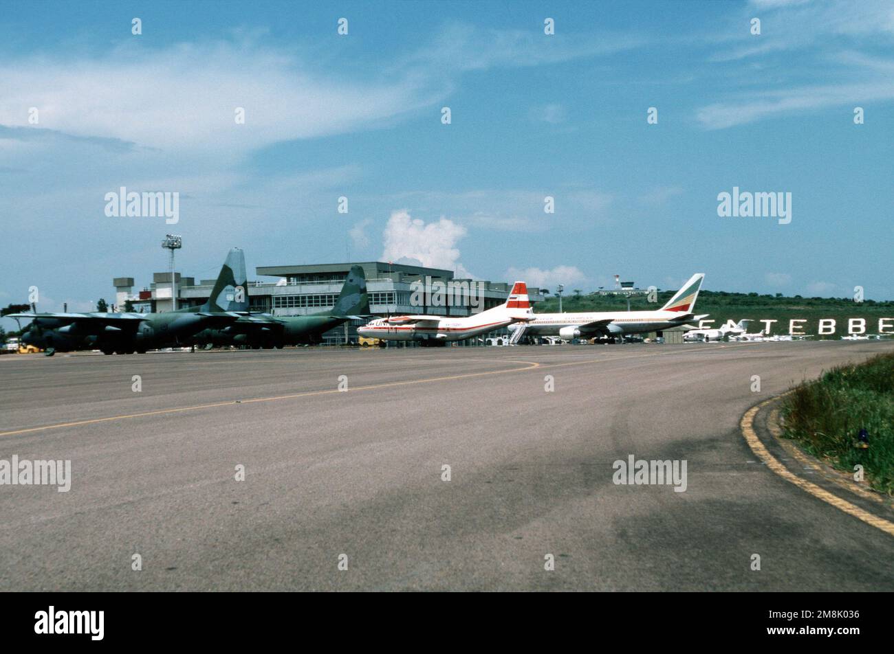 A wide angle view of the airfield at Entebbe, Uganda showing two C-130 ...