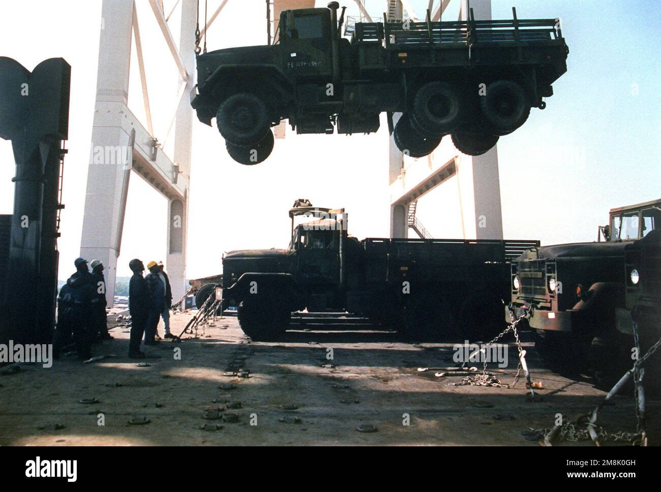 Two and a half ton truck, being loaded on the USNS DENEBOLA, at the ...