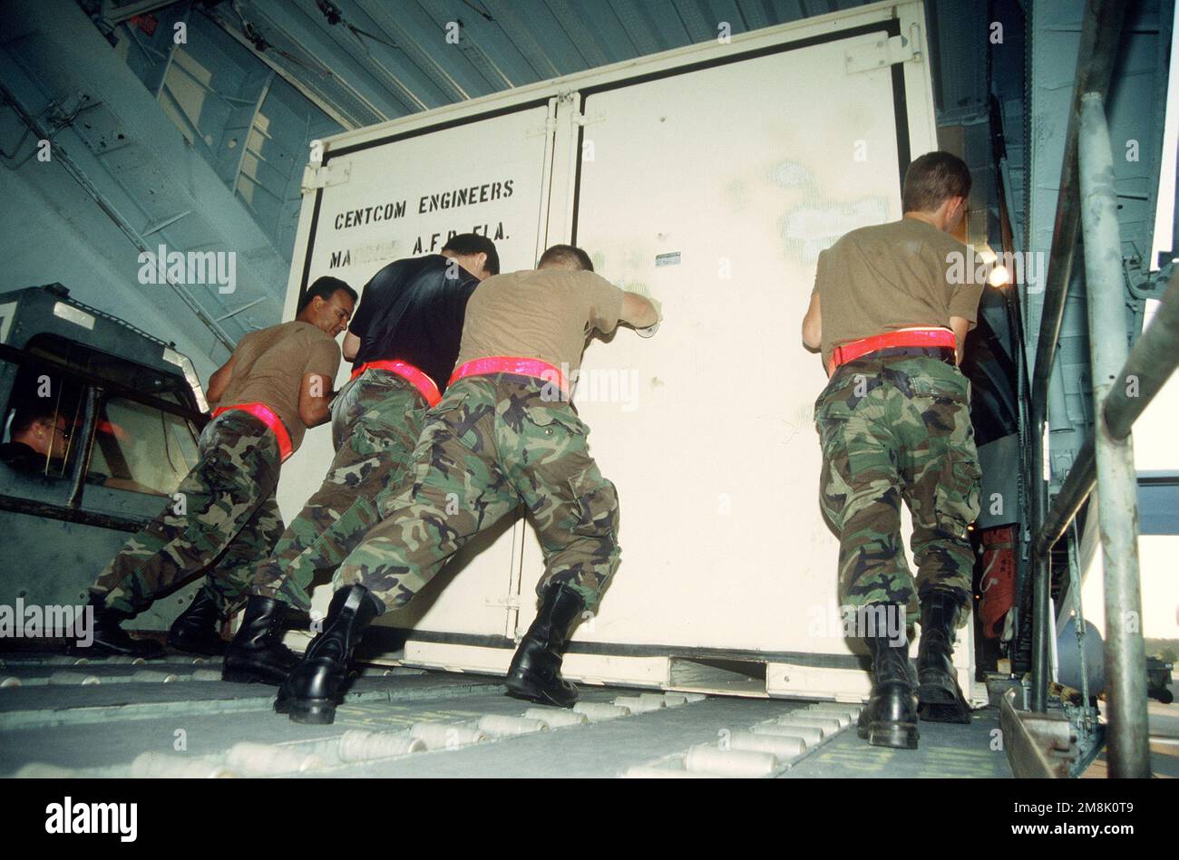Members of a US Central Command team from the MacDill AFB, Fla. deployment team load a C-141 ...