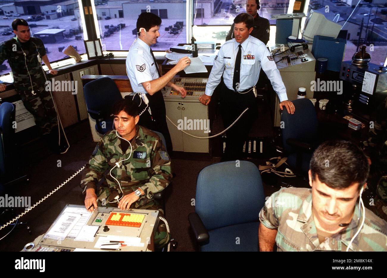 Air Traffic Controllers in the control tower monitor flight operations ...