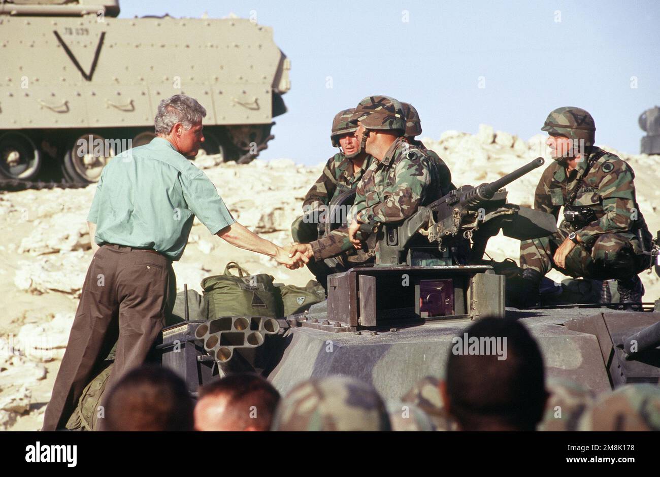 President William Jefferson Clinton stands on an M-1A1 Abrams tank to ...