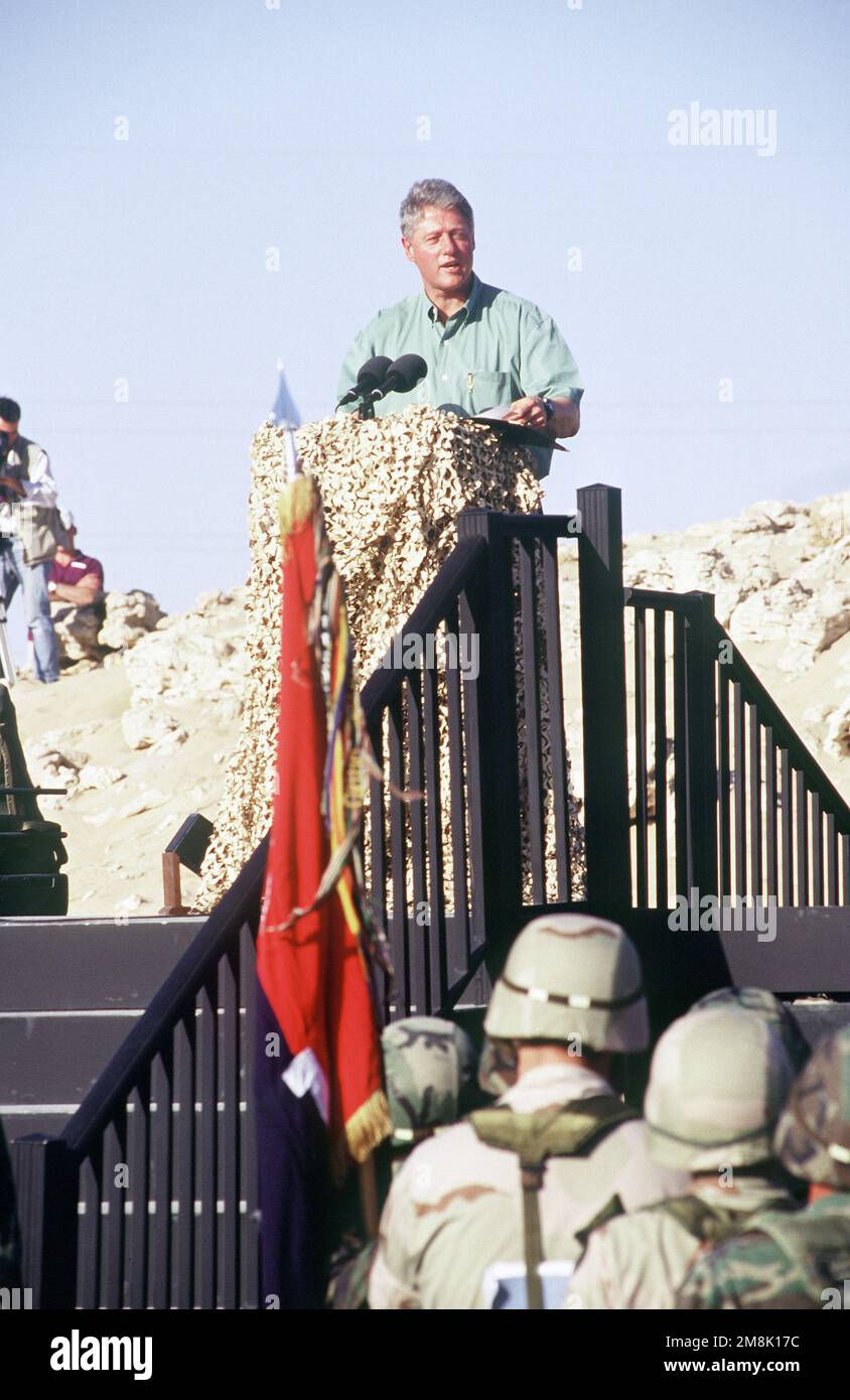 President William Jefferson Clinton, standing behind a podium covered ...
