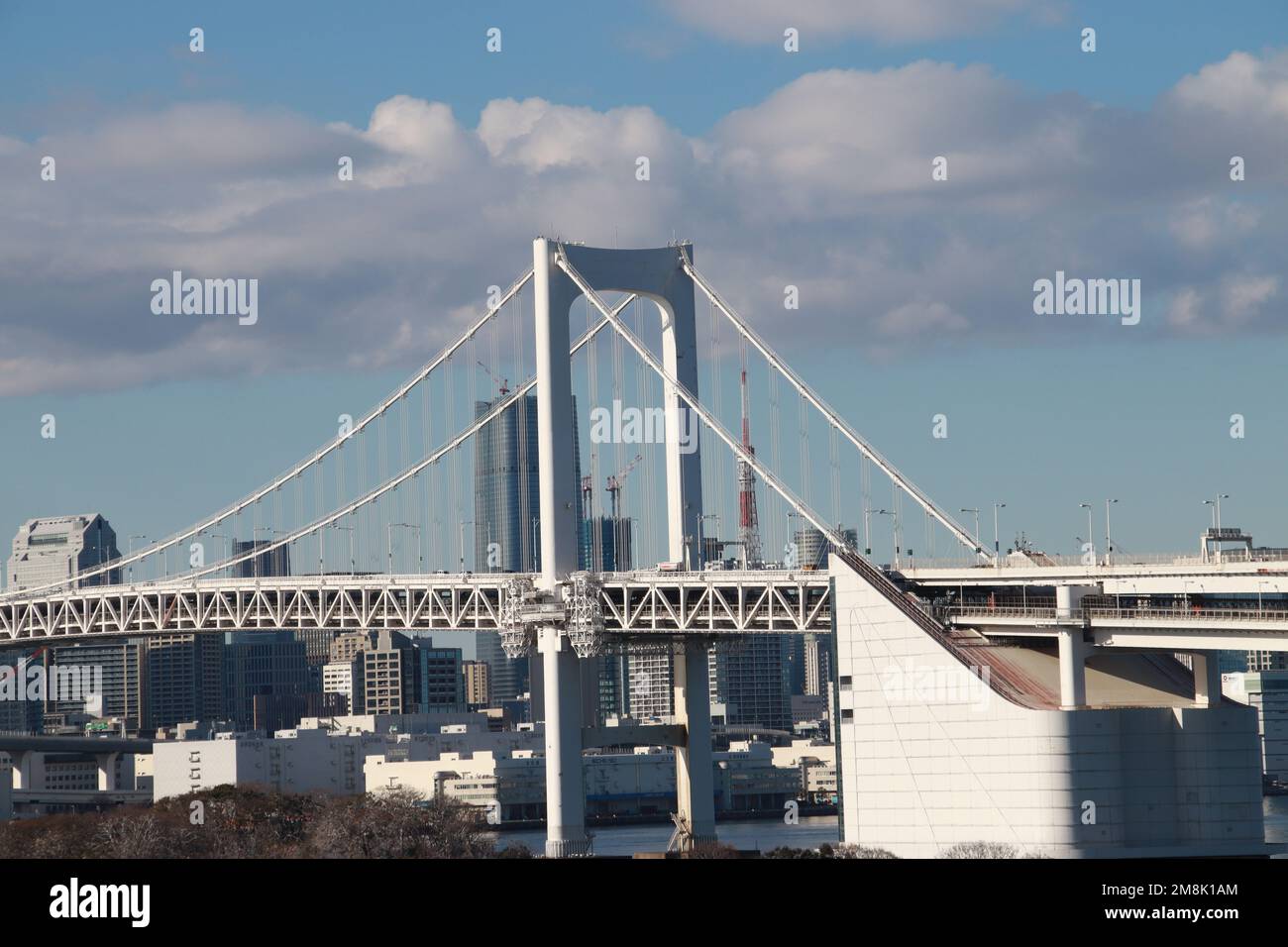The Rainbow Bridge in Tokyo, Japan against a blue sky Stock Photo - Alamy