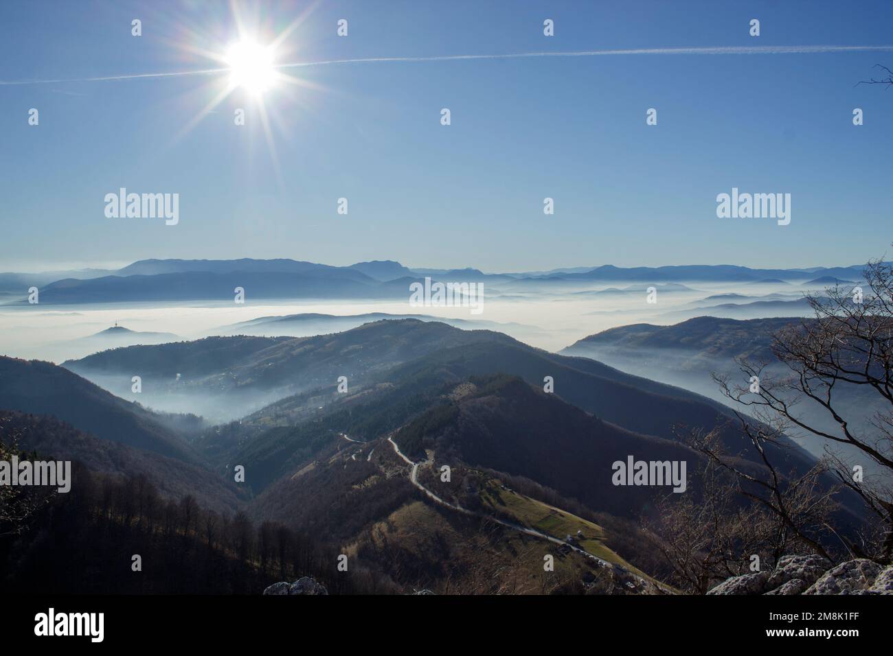 A landscape view of the mountains and hills against a blue sky in ...
