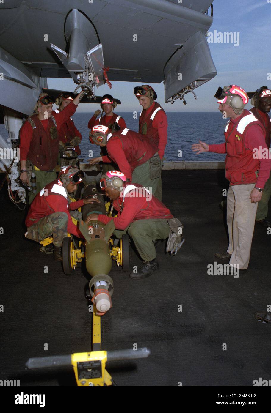 Aviation ordnancemen from Attack Squadron 196 (VA-196) prepare to lift ...
