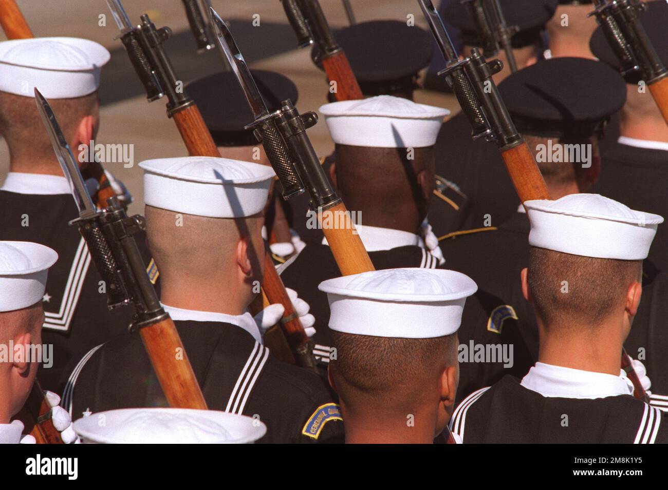 Rear view of the Navy Ceremonial Honor Guard marching in formation ...