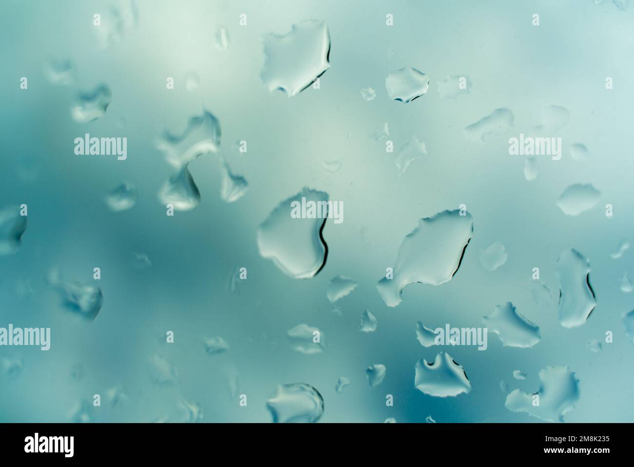 Water drops on glass against blue sky, rainy season concept. Window ...