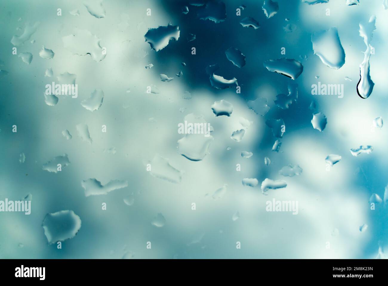Water drops on glass against blue sky, rainy season concept. Window ...