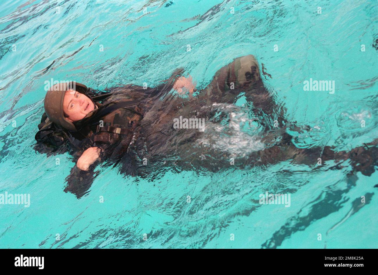 Marine CPL. Melanie Burkett makes her way the length of the pool to ...