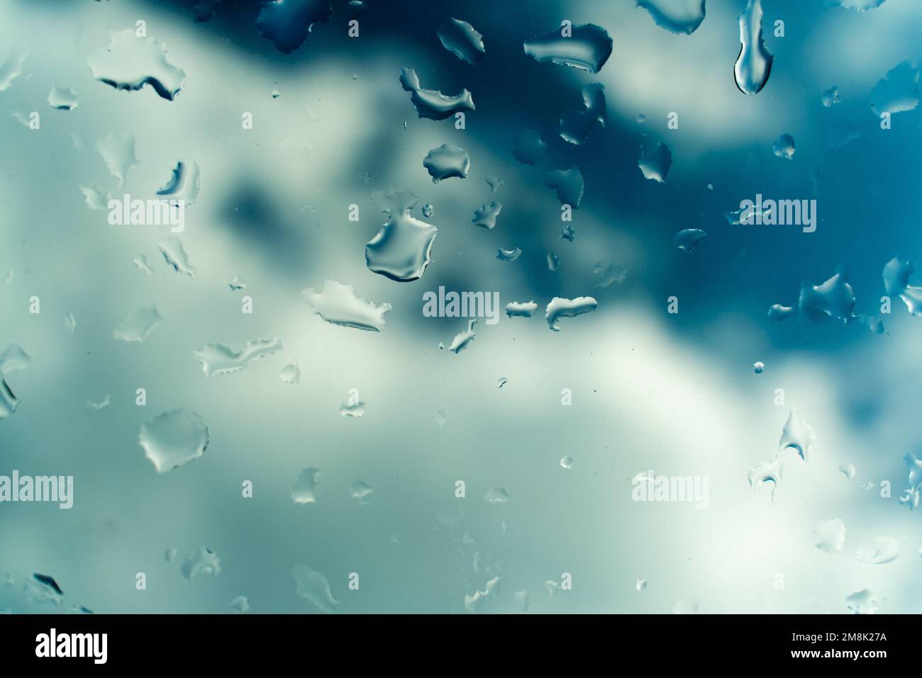 Water drops on glass against blue sky. Window view background ...