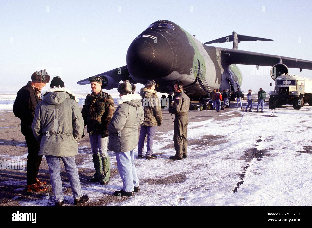 Air crew and passengers get off a C-5 Galaxy to begin their missions ...