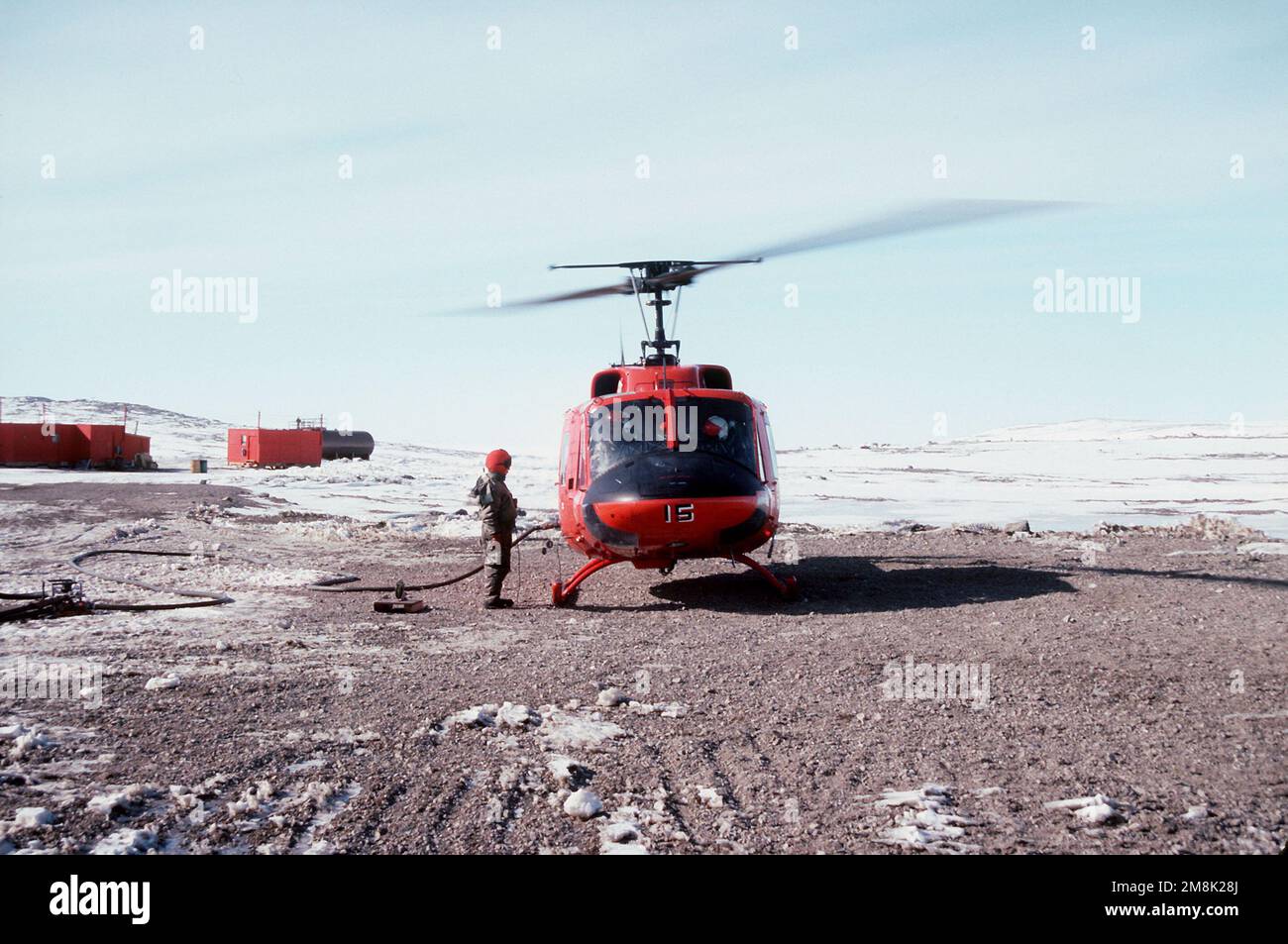 Front view of a UH-1 Iroquois Huey helicopter being fueled at McMurdo ...