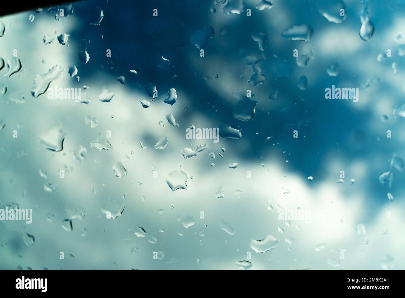 Water drops on glass against blue sky, rainy season concept. Window ...