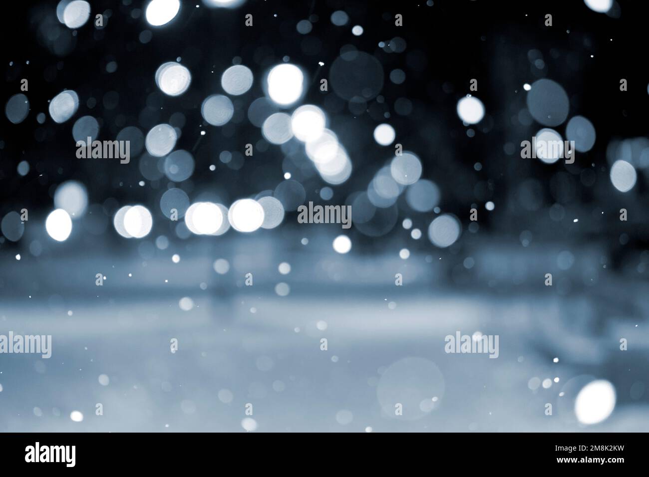 Blurred background. City view, lights, falling snow, night, street ...