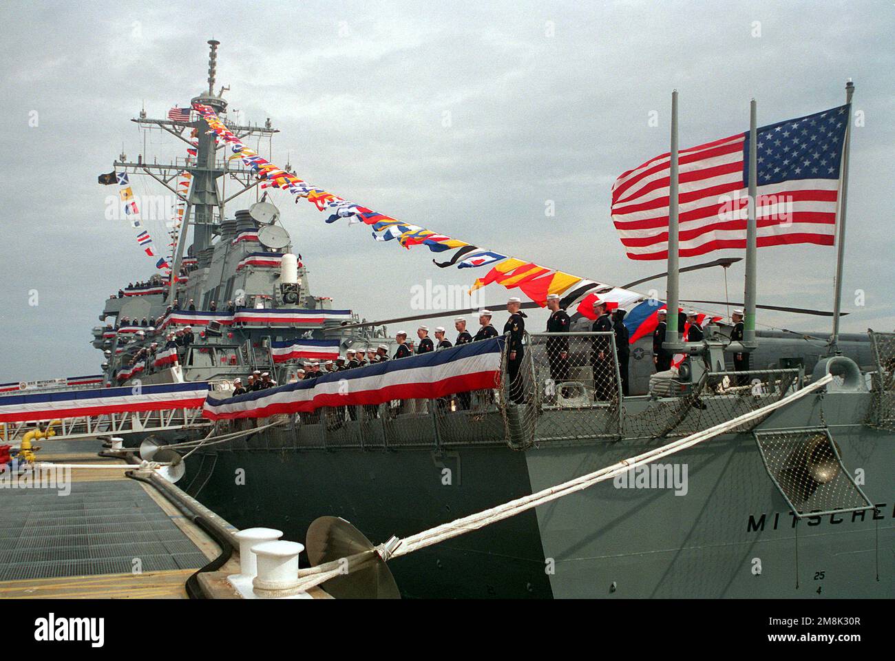 Crewmembers of the guided missile destroyer USS Mitscher (DDG-57) man ...