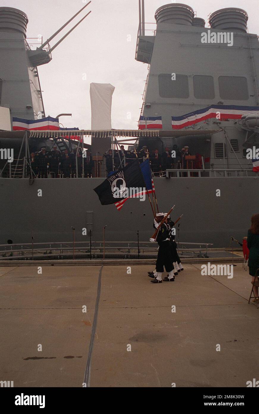 Crewmembers of the guided missile destroyer USS Mitscher (DDG-57) form ...
