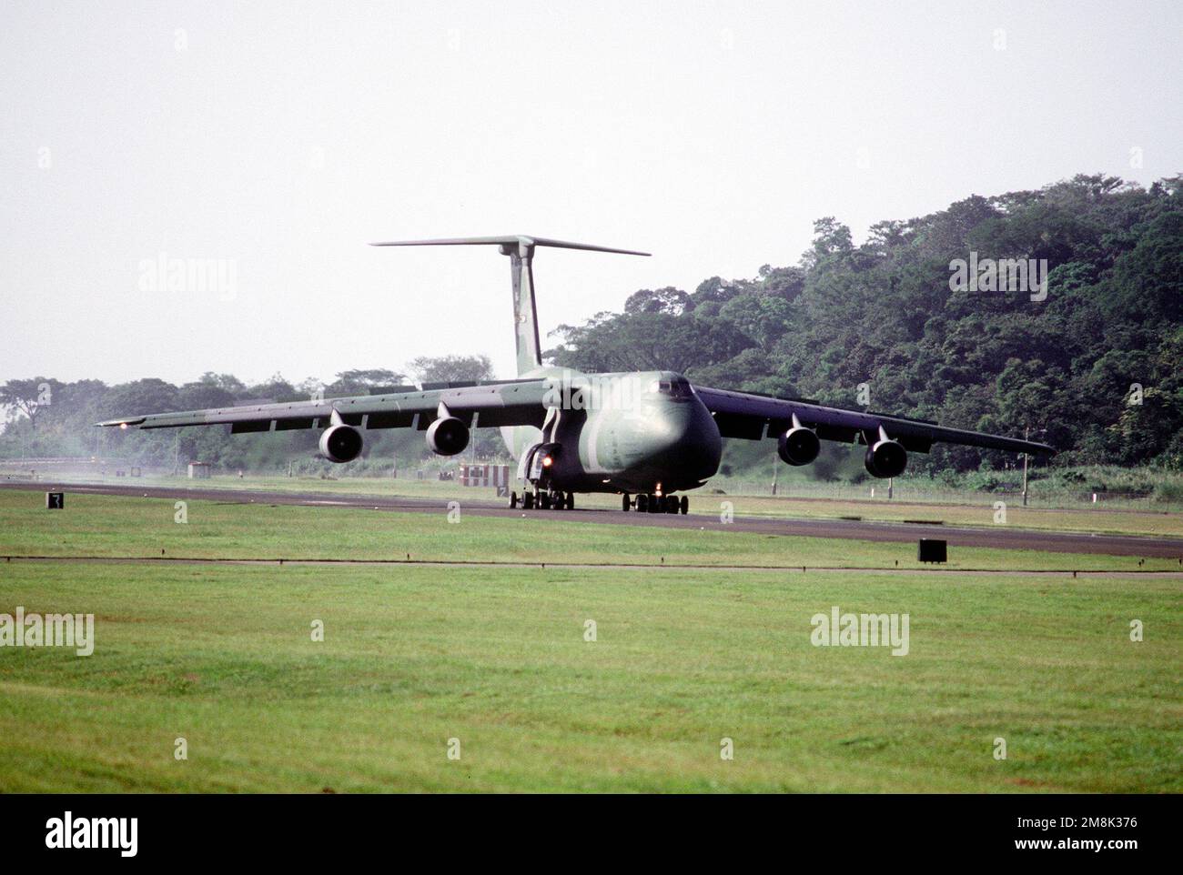 A U.S. Air Force C-5 Galaxy lands and taxis at Howard AFB. The aircraft ...