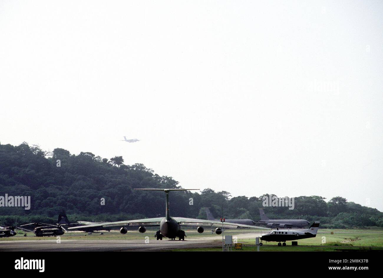 A U.S. Air Force C-141 Starlifter (rear view) taxis down the ramp in ...
