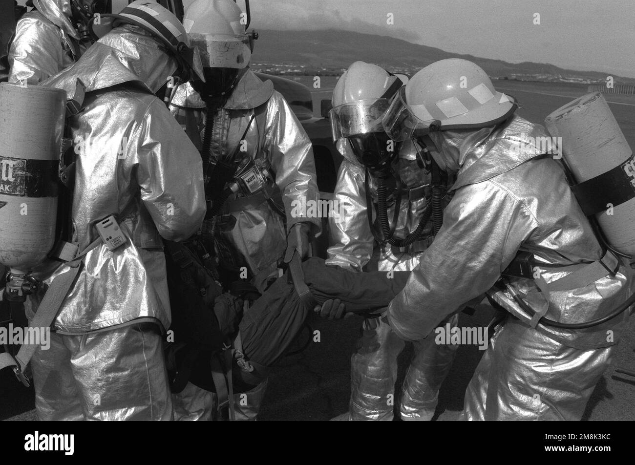Base Firemen pull an astronaut from a mock Shuttle during an emergency ...