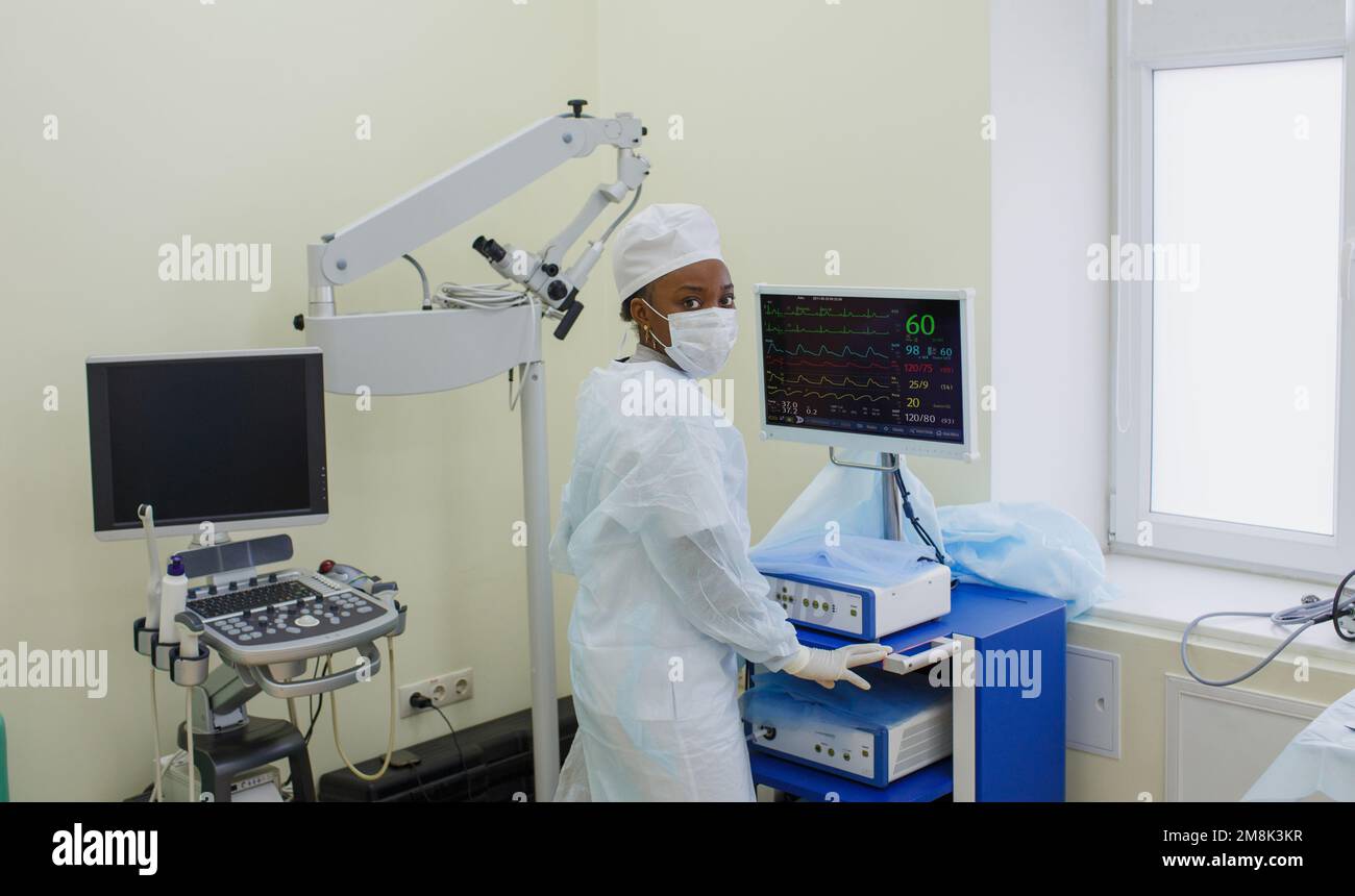 an African-American nurse near the screen of artificial ventilation ...