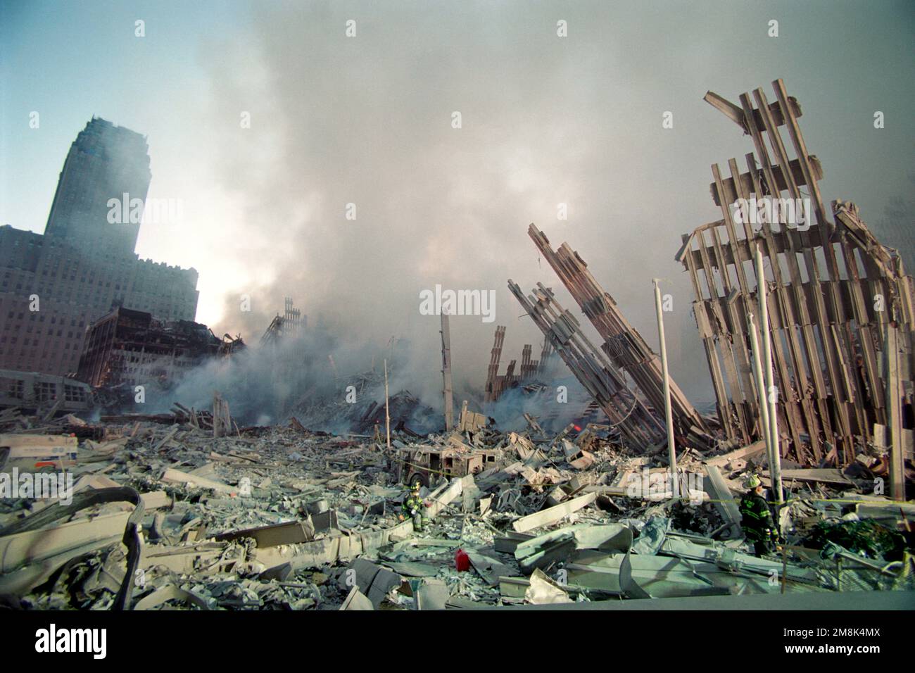 New York City firefighters are dwarfed as they are surrounded by ...