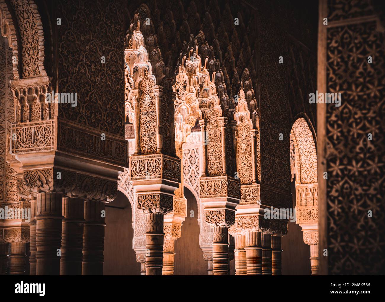 The Arabesque-style columns and wall decorations illuminated by the ...
