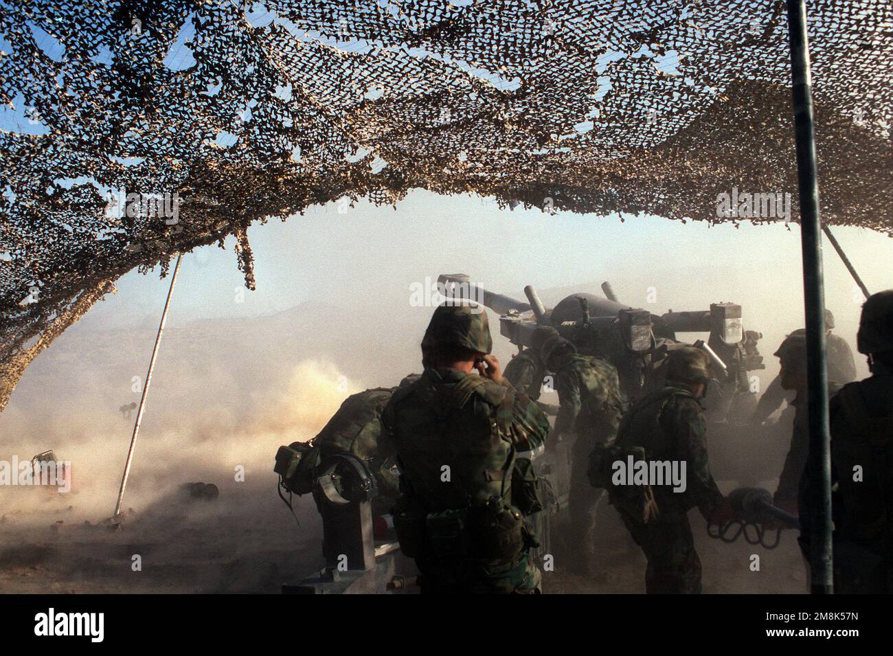 Left rear view, camera under camouflage netting. An M198 155 mm ...