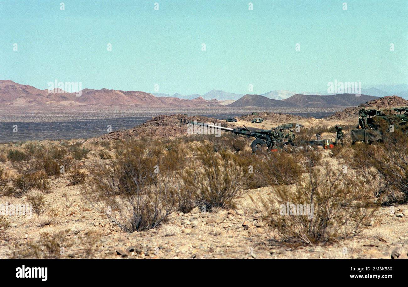 Long shot, left side view, M198 155mm Howitzer in firing position. M813 ...