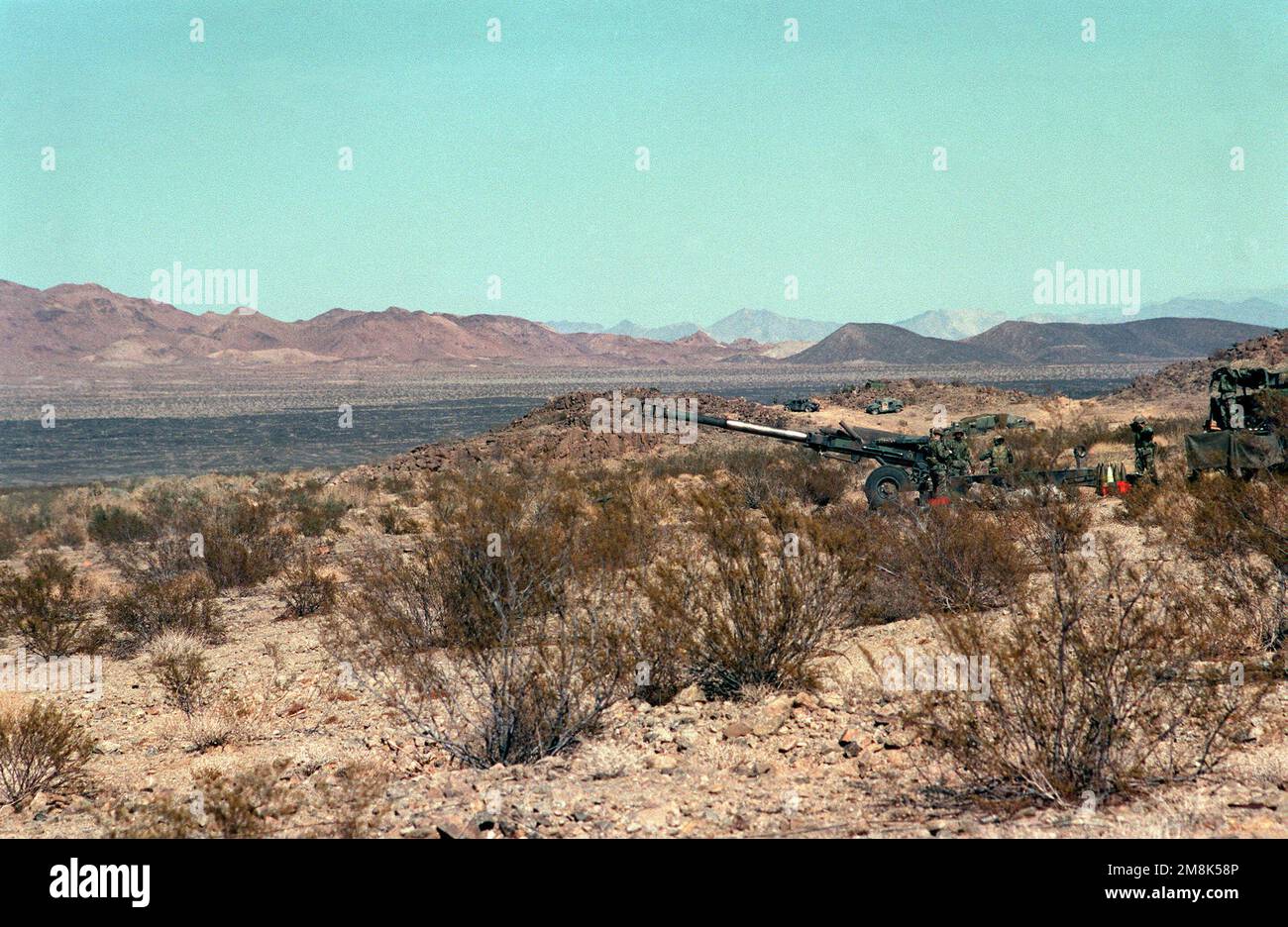 Long shot, left side view, M198 155mm Howitzer in firing position. M813 ...