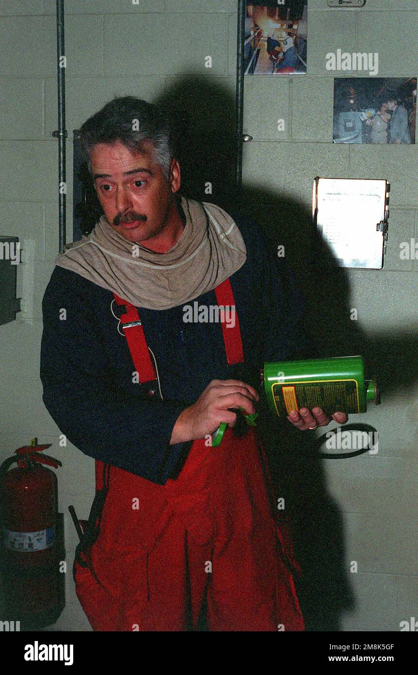 Machinist Mate First Class (MM1) Phelix shows how to properly place an ...