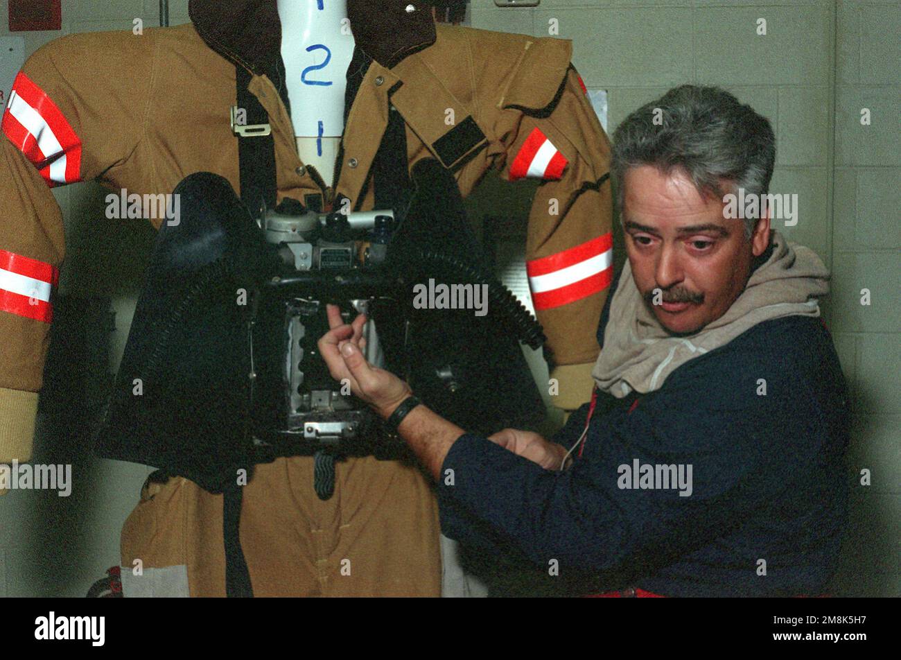 Machinist Mate First Class (MM1) Phelix demonstrates how to properly ...