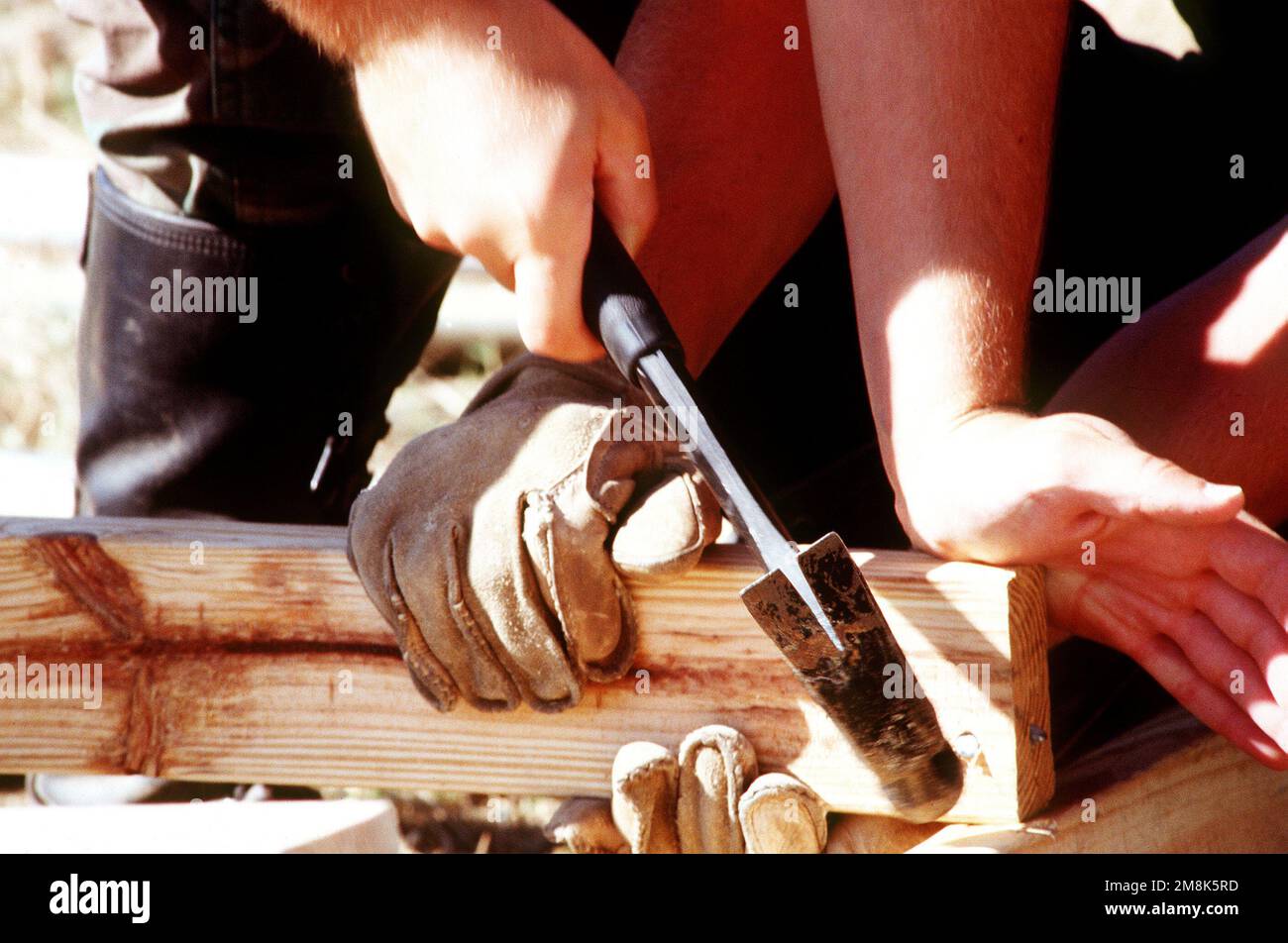 U.S. Army soldiers construct a frame for a hardback tent for use by ...