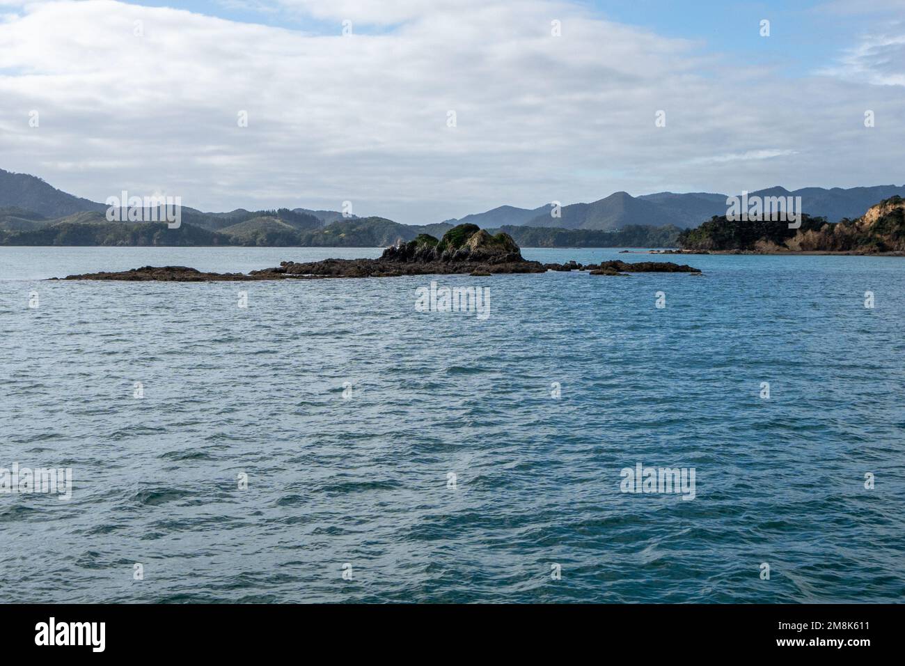 A sunlit seascape view with cloudy sky background, Bay of islands Stock ...