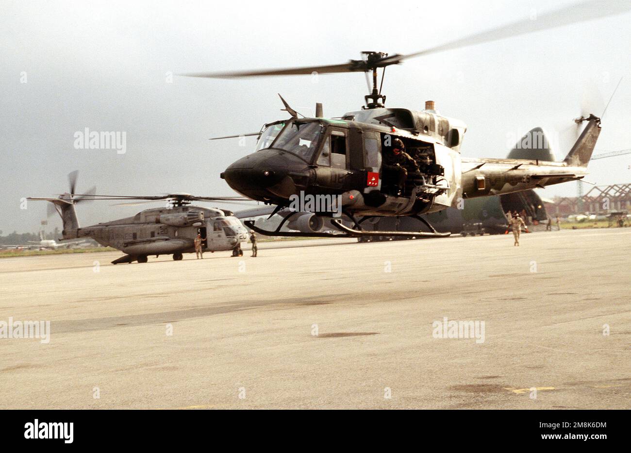 A US Marine Corps UH-1 Huey helicopter lifts off from the ramp at Moi ...