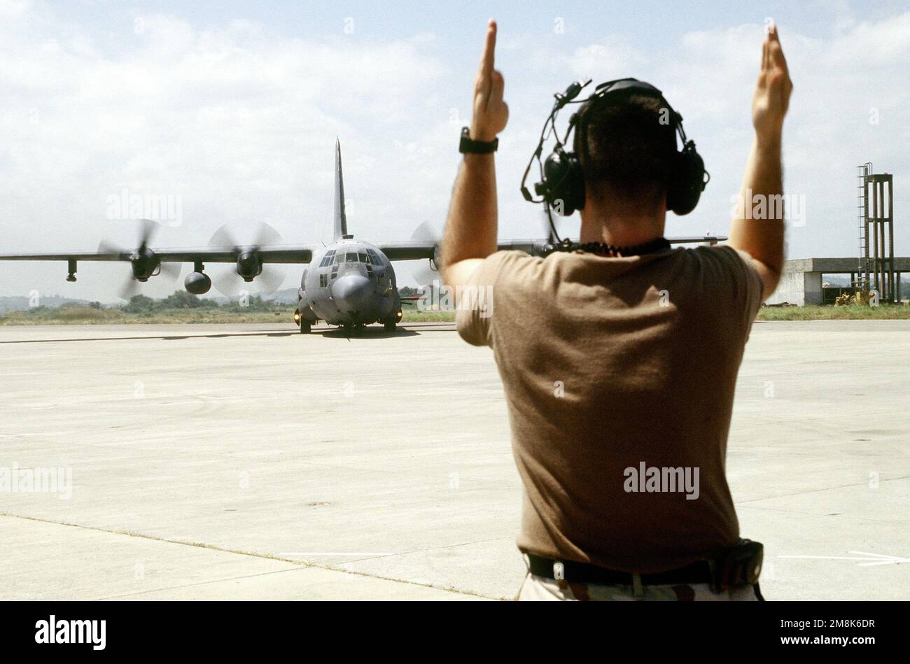 A U.S. Air Force AC-130 Hercules gunship is directed to a parking spot ...