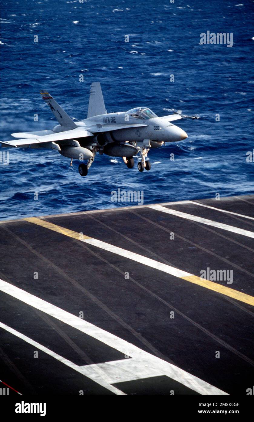 An F/A-18 Hornet, assigned to USS THEODORE ROOSEVELT (CVN-71) is just ...