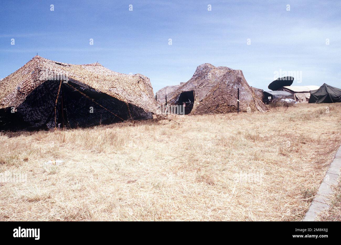 Camouflaged netting covers a joint military communication center. The ...
