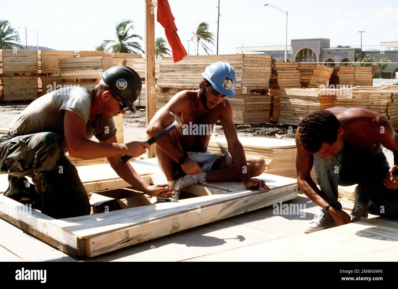 U.S. Navy Seabees work with Cuban migrants in building hardback tent ...