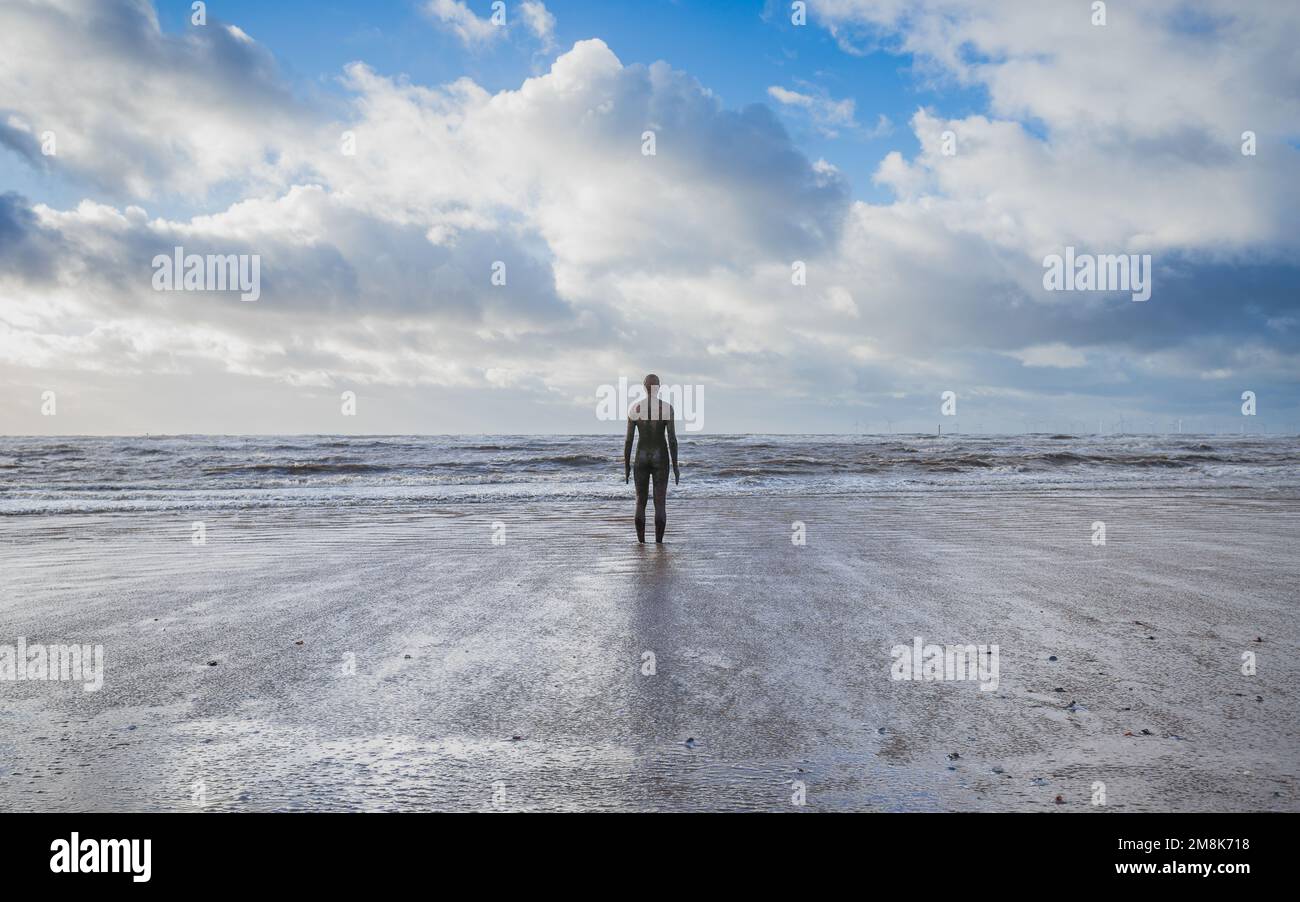Strong winds blow sea water around an Iron Man statue on the beach at ...