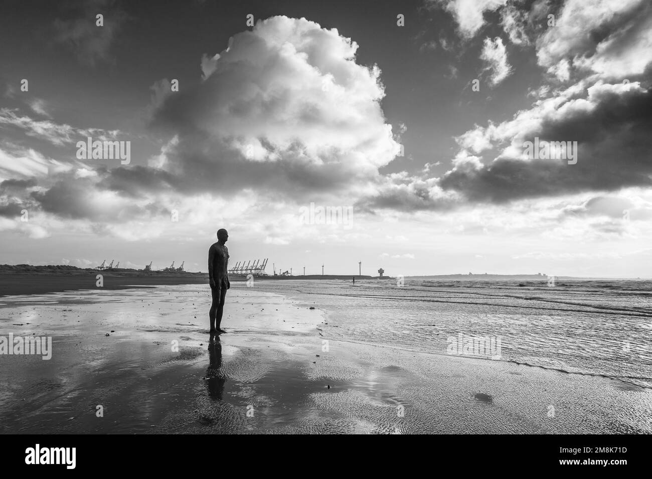 A bright winters sky casts an Iron Man as a silhouette on Crosby beach ...