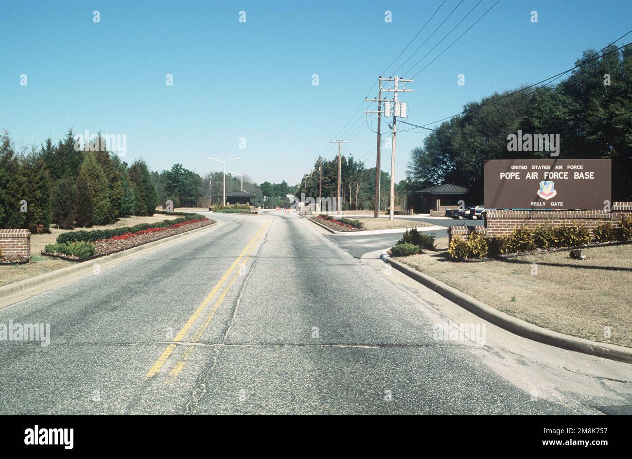 A long view of the main gate and the base sign. Base: Pope Air Force ...