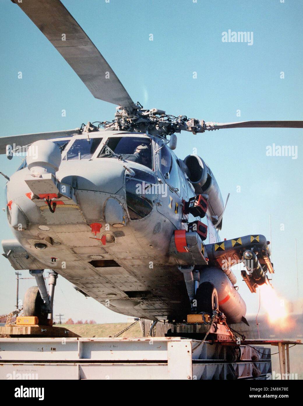 A Hellfire laser-guided anti-armor missile is test fired from an SH-60F ...