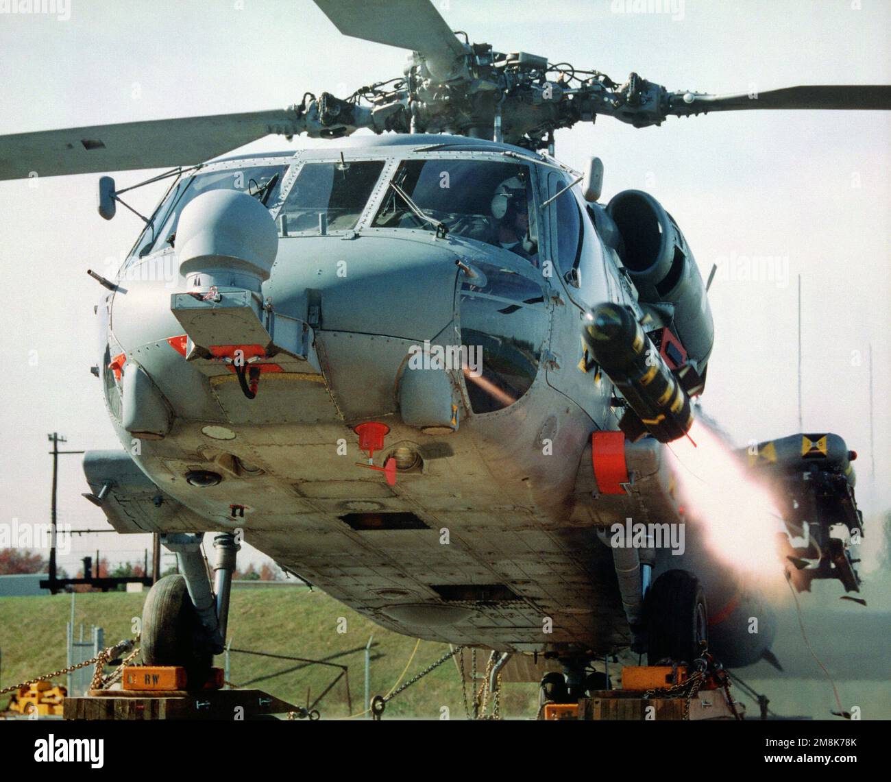 A Hellfire missile roars off the port launching rail of an SH-60F ...