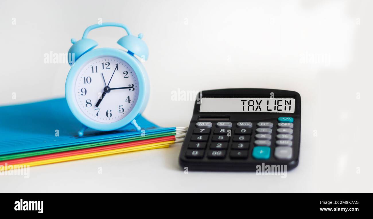 TAX LIEN. white background text on calculator display Stock Photo - Alamy