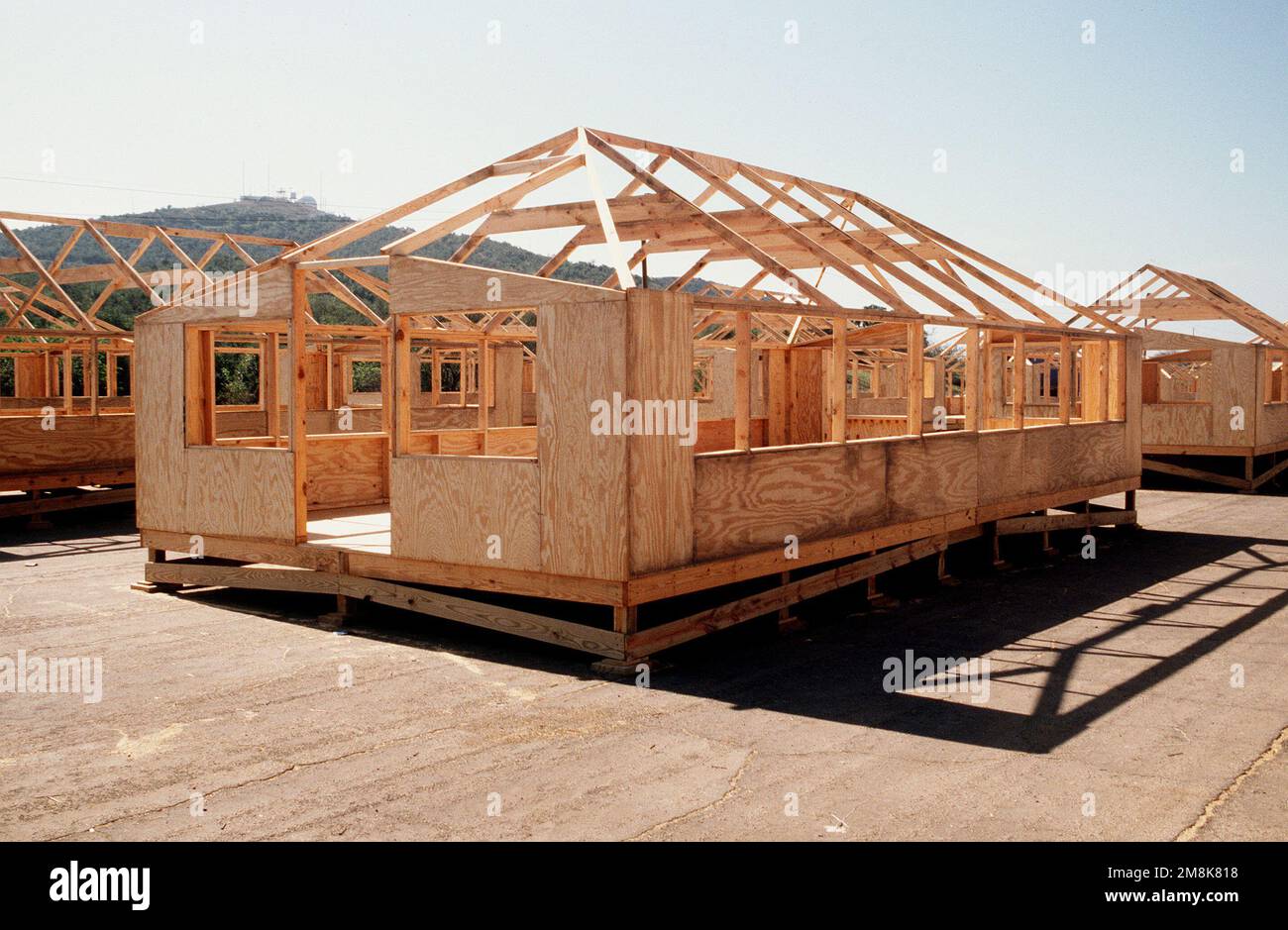 Hard back tent frames are lined up at Camp Five. U.S. Navy Seabees from ...