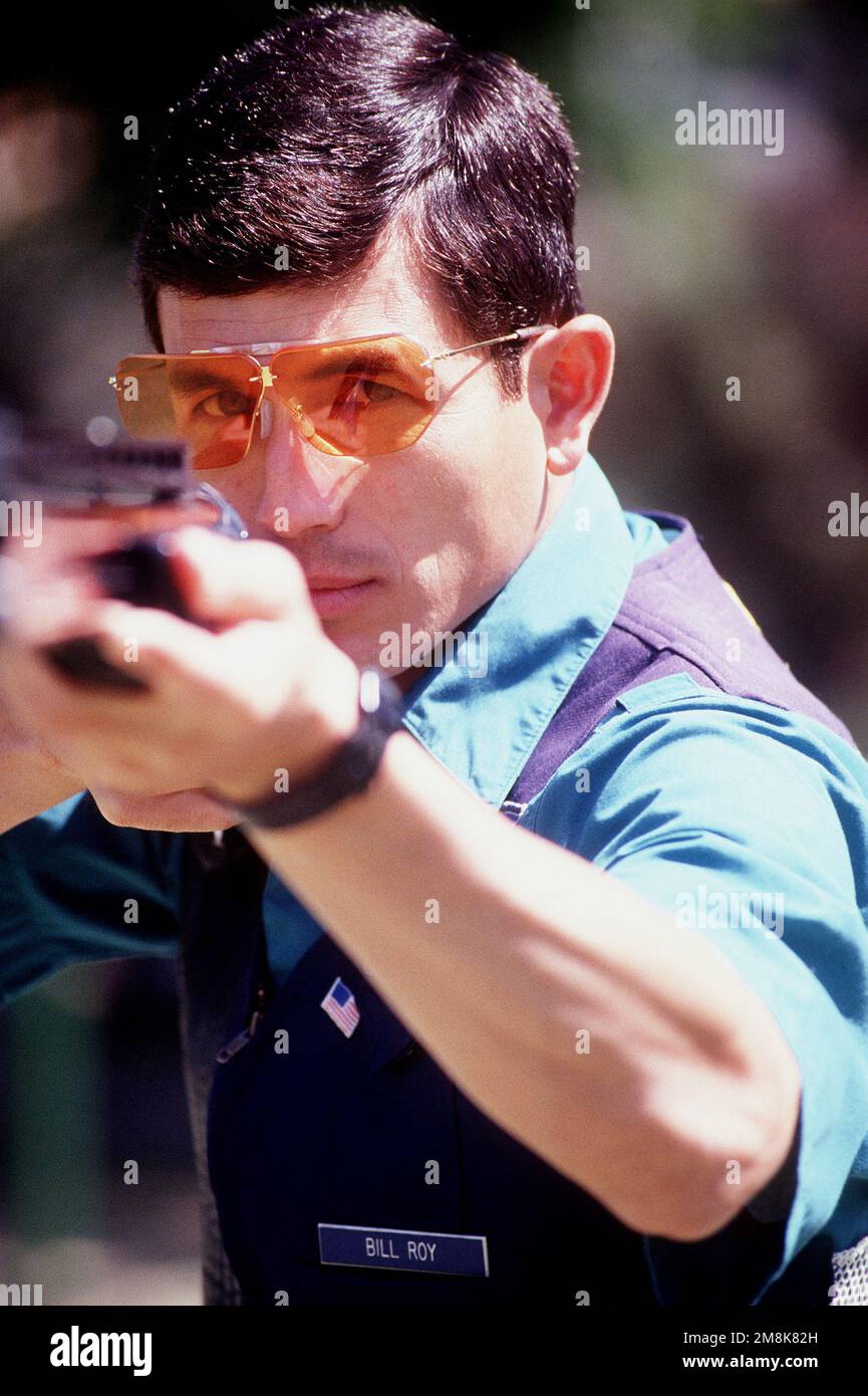 MAJ. Mike Roy, US Air Force, sights down the barrel of his shotgun at ...