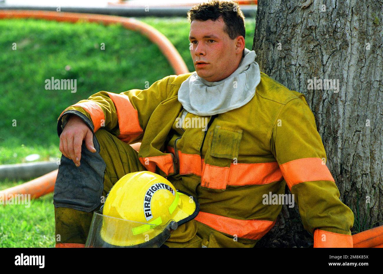 AIRMAN (AN) Thomas Gardner rests after being relieved from a hose team ...