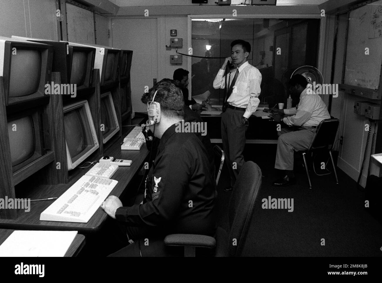 A Japanese naval officer mans the telephone to relay information at one ...